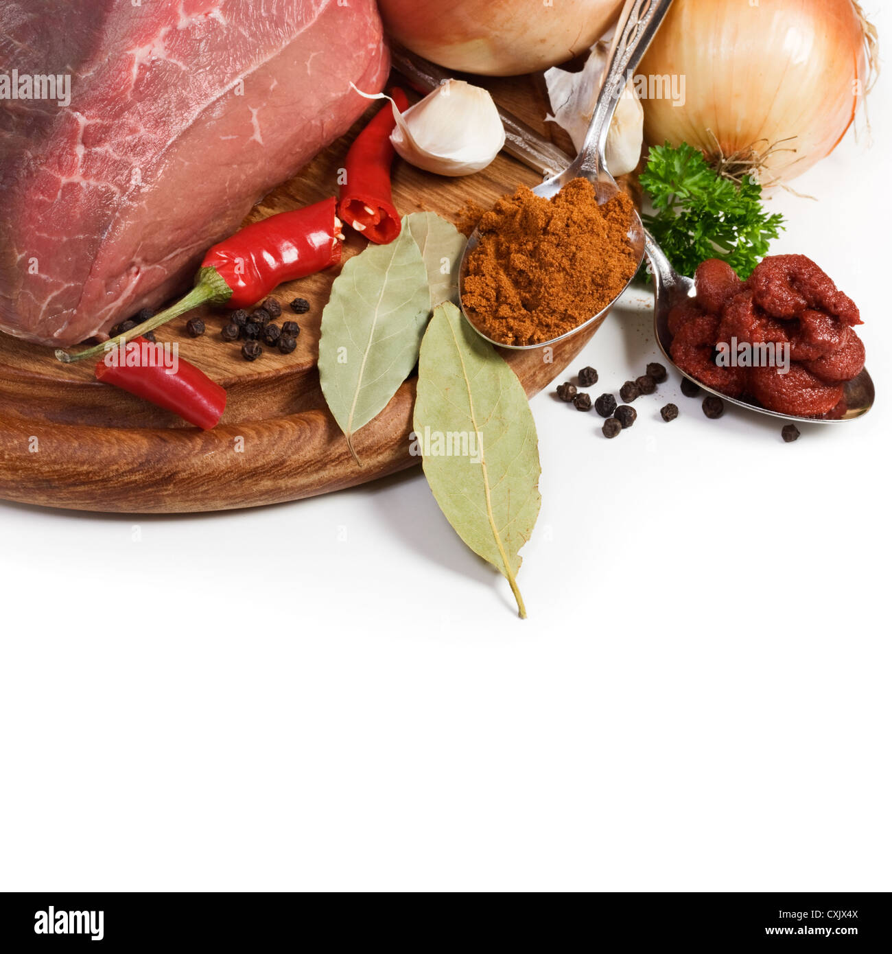 Meat and ingredients for goulash on chopping board, close-up, white ...