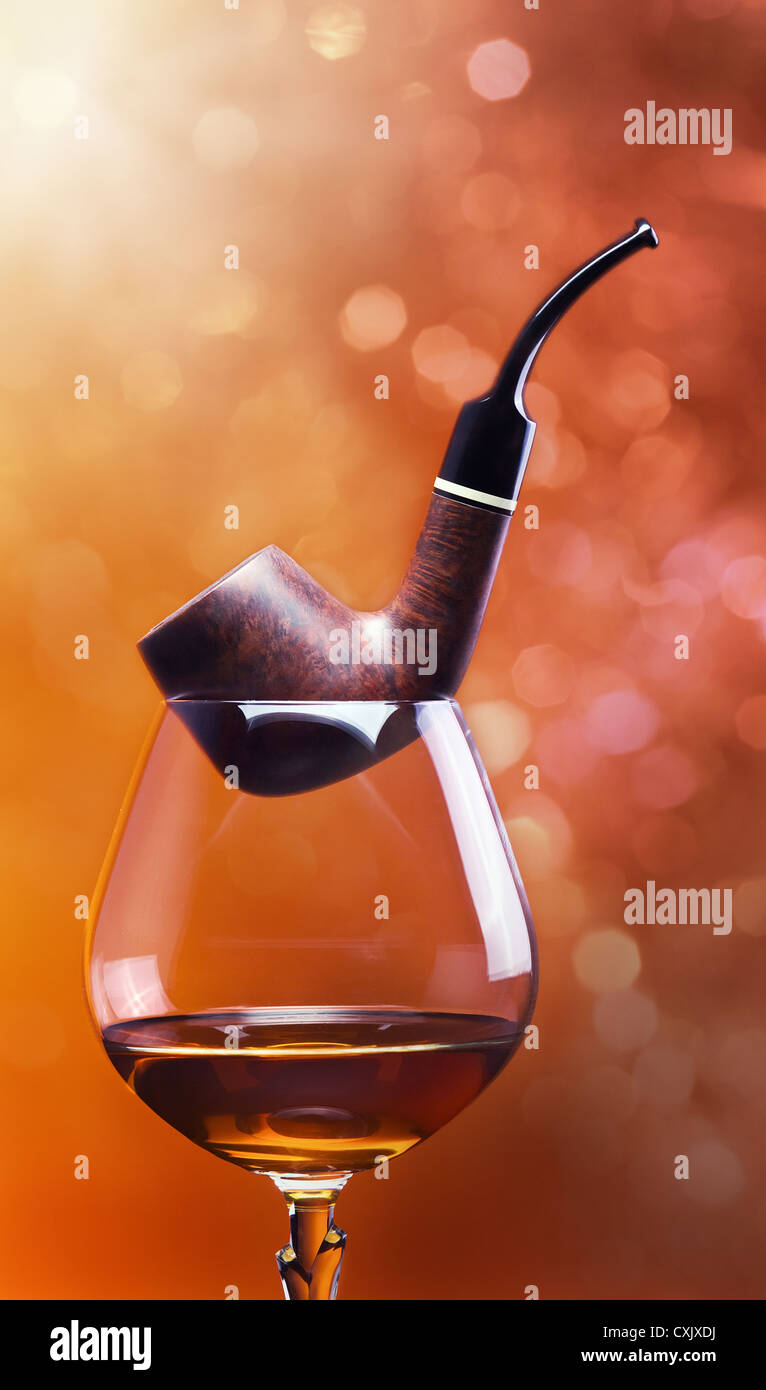 cognac and pipe on a bright background Stock Photo - Alamy