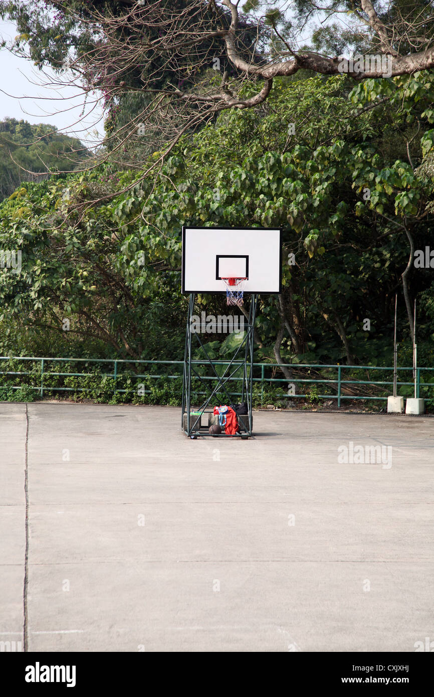 It's a photo of the basketball hoop in a playground in the suburbs near ...