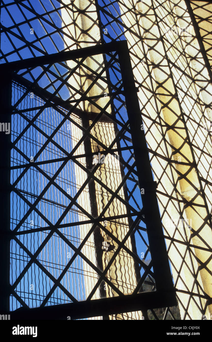 Diamond-leaded window standing open in wall of high plain leaded ...