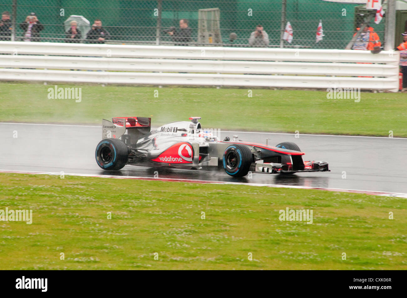 Jenson Button in his Lotus F1 Car in the Wet Stock Photo - Alamy