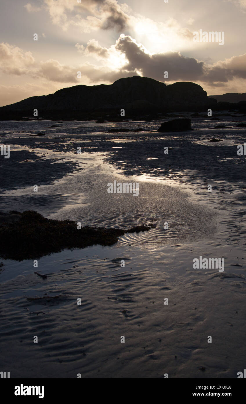 Isle of Mull, Scotland. Picturesque silhouetted view of Fidden Beach on ...