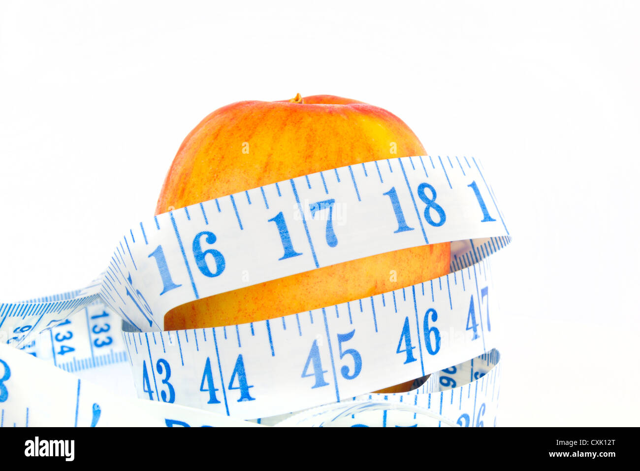 Apple with tape measure isolated on a white background Stock Photo - Alamy