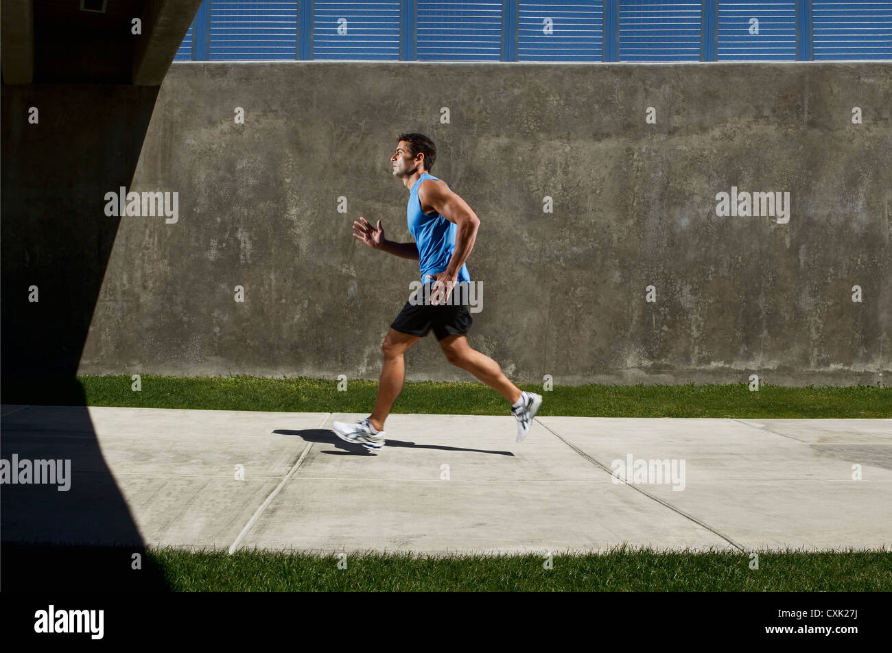 Man Running on Sidewalk Stock Photo - Alamy
