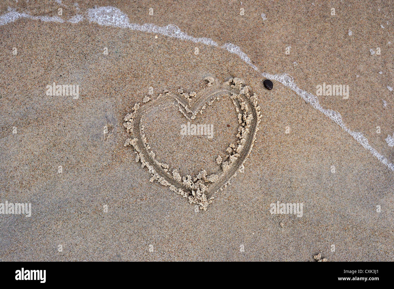 Picture of heart made on sand Stock Photo - Alamy