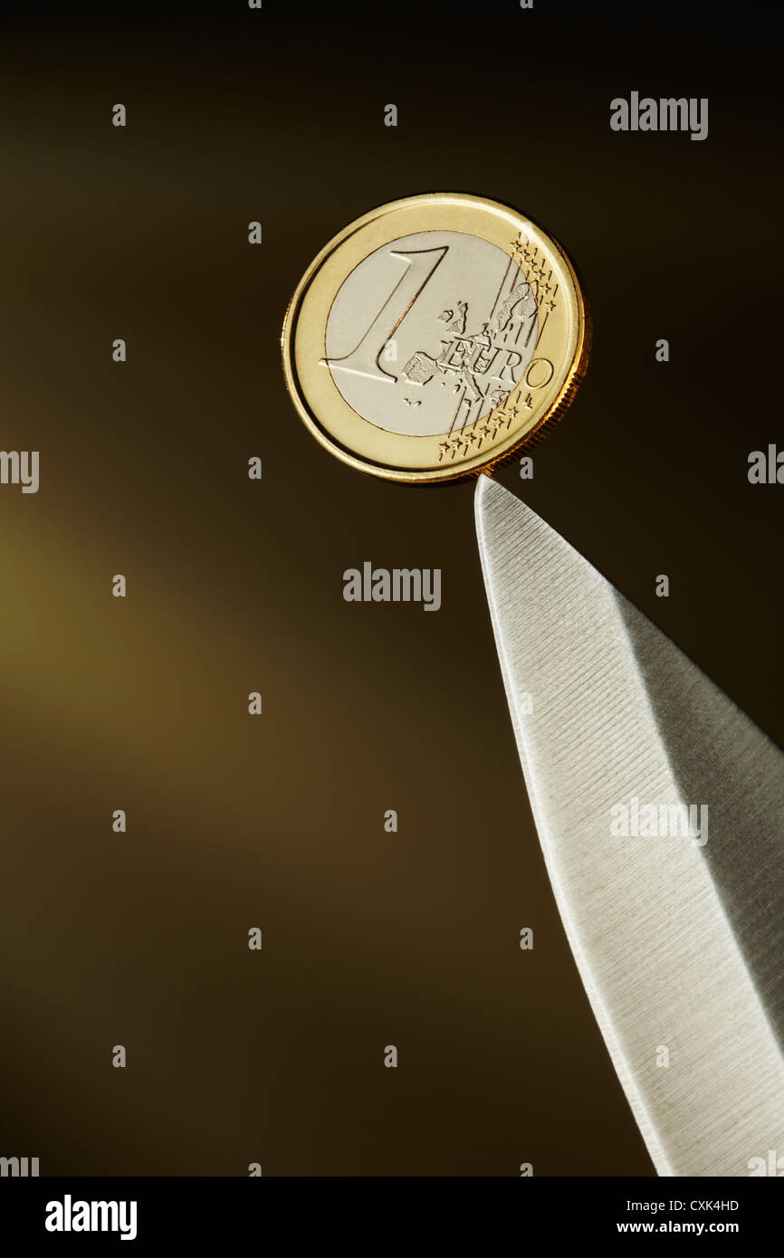 Euro Coin on Knife Edge Stock Photo - Alamy