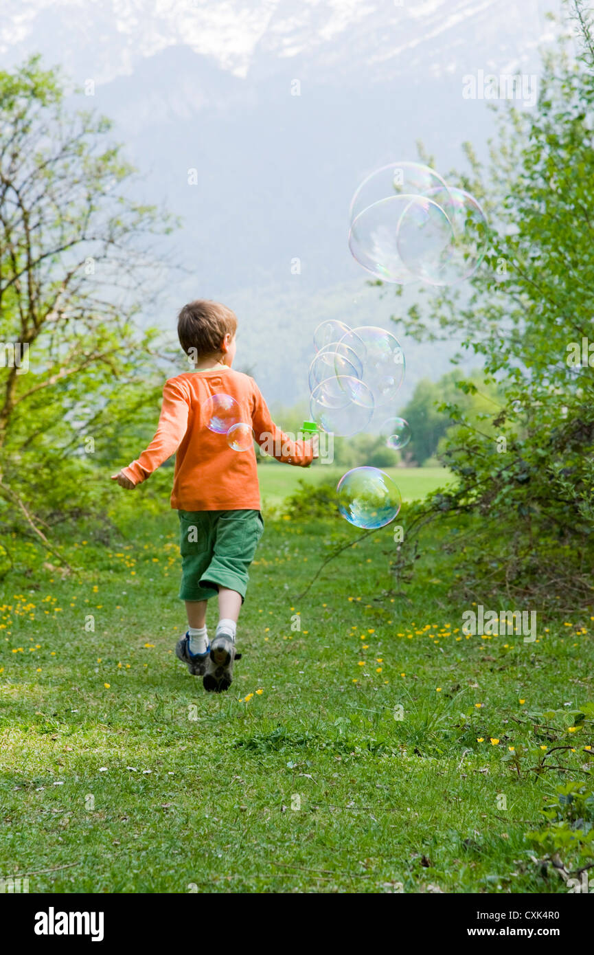 Boy Running and Blowing Bubbles, Salzburg, Austria Stock Photo - Alamy