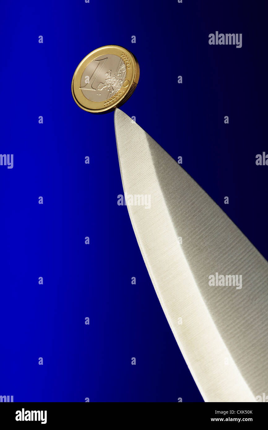 Euro Coin on Knife Edge Stock Photo - Alamy