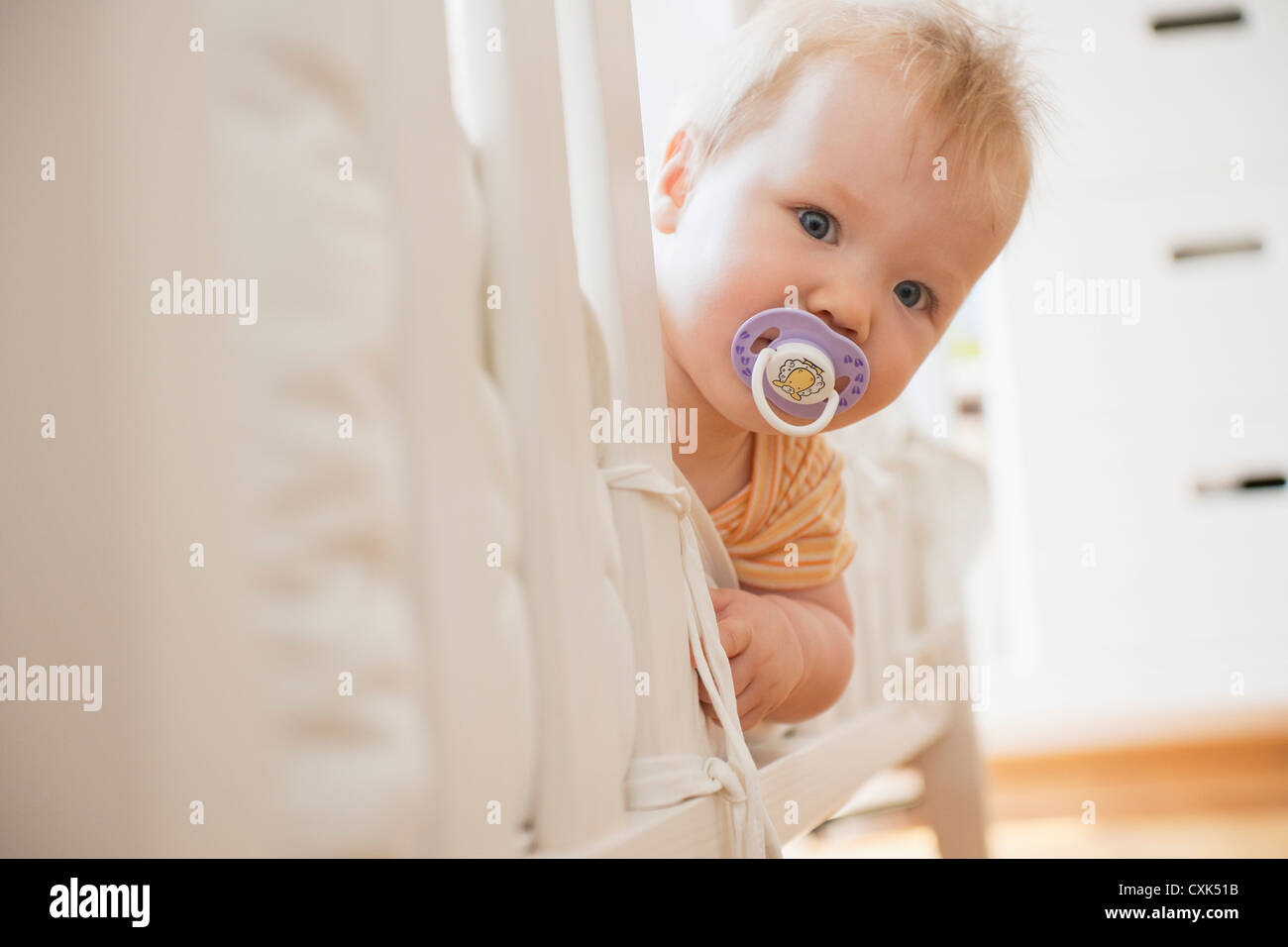 Portrait of Baby Girl Looking out from Crib Stock Photo - Alamy