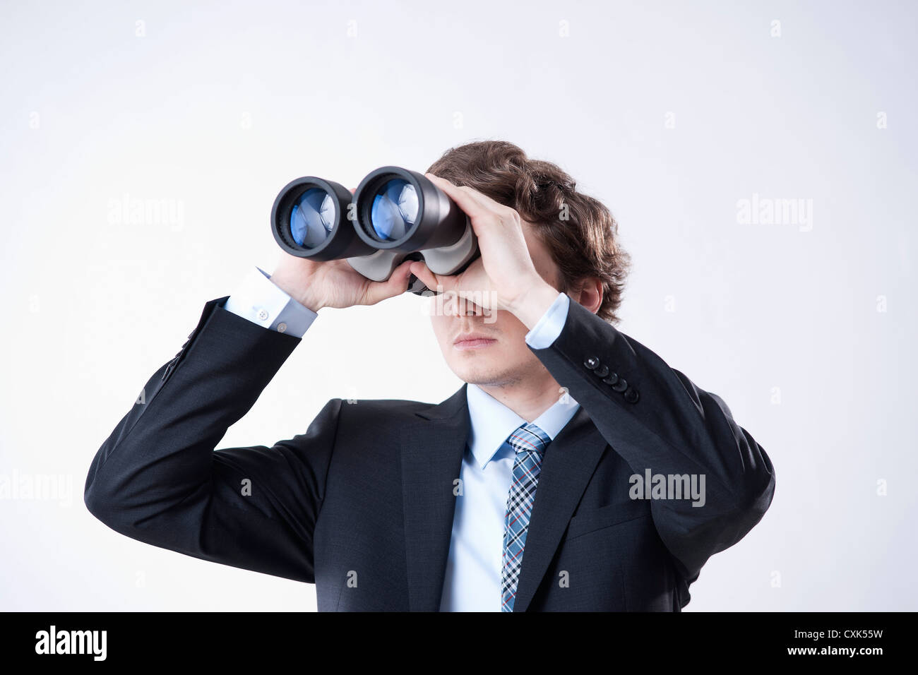 Young Businessman Looking through Binoculars Stock Photo - Alamy
