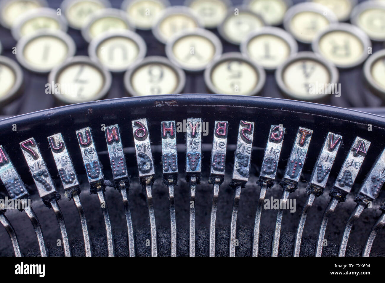 A closeup of an antique typewriter and the keys and letters and bars ...