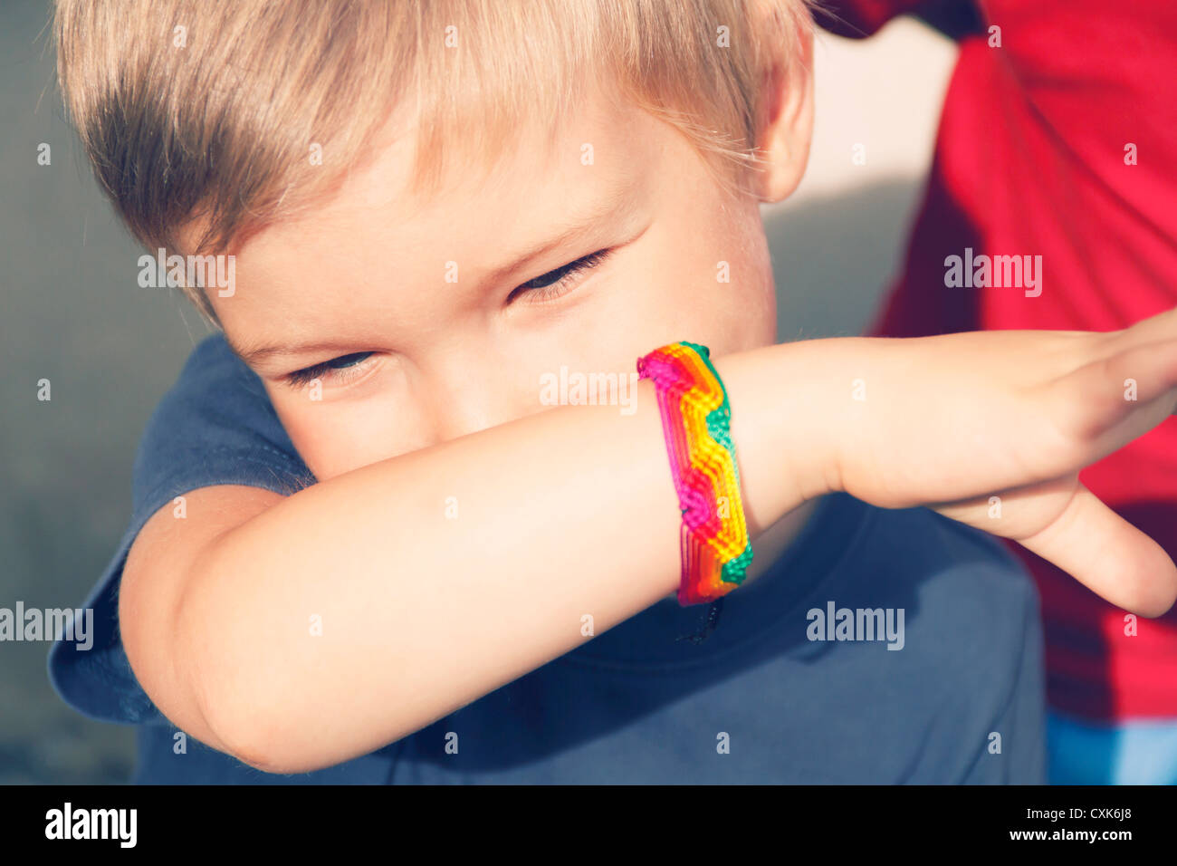 Boy (4-5) wearing colorful wristband, France Stock Photo - Alamy