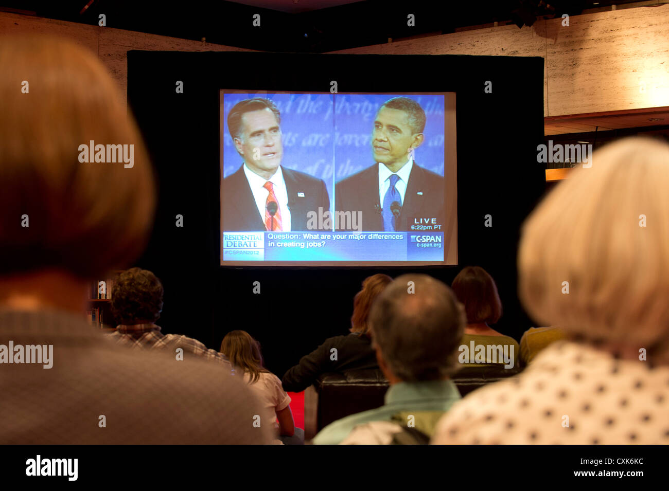 Likely voters watch large TV screen showing televised debate between US ...