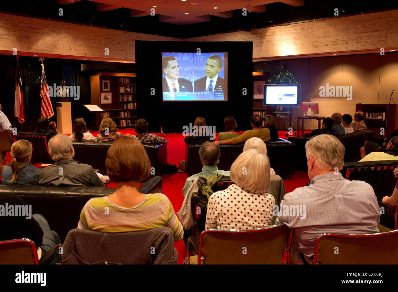 Likely voters watch large TV screen showing televised debate between US ...