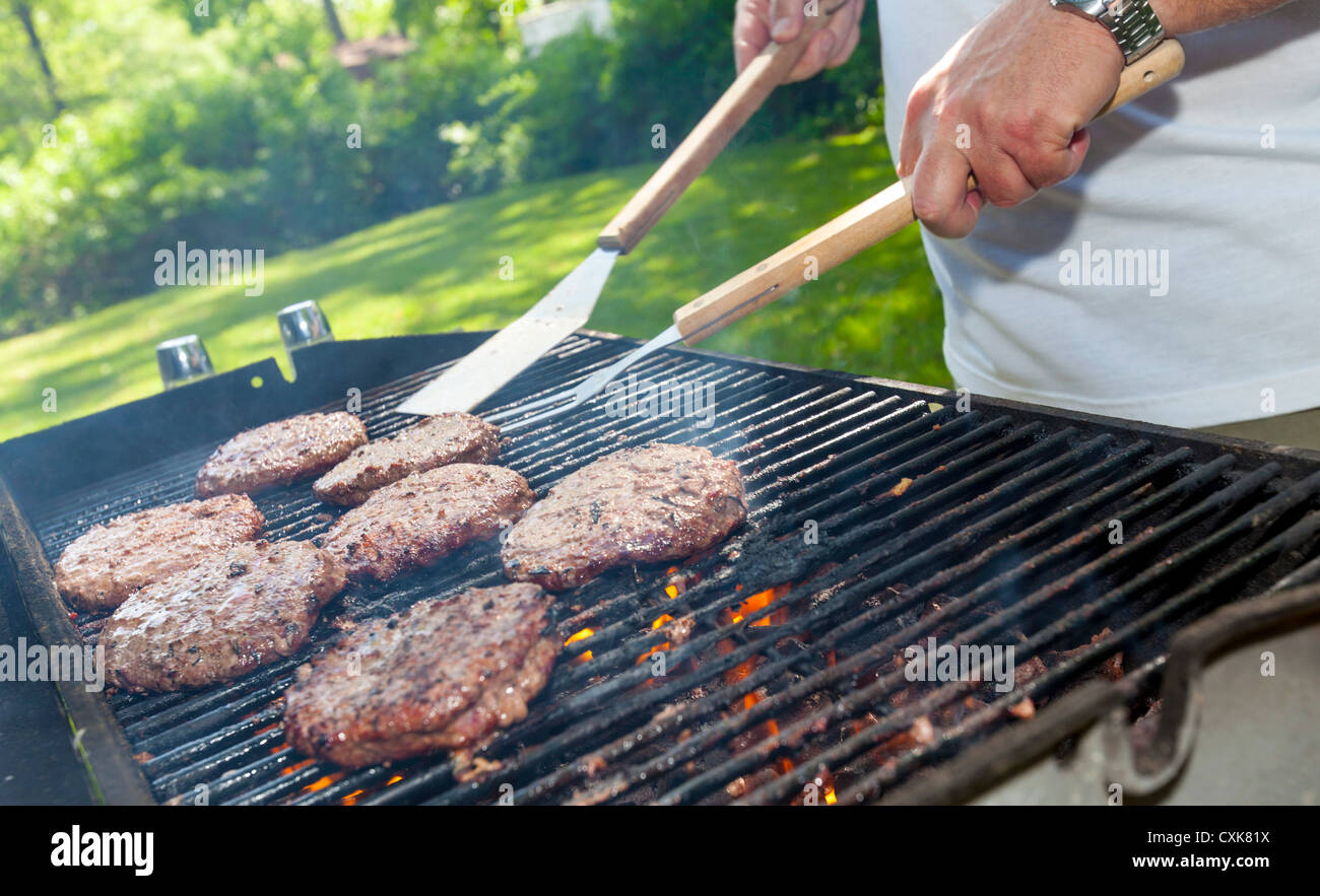 Man Grilling Hamburgers
