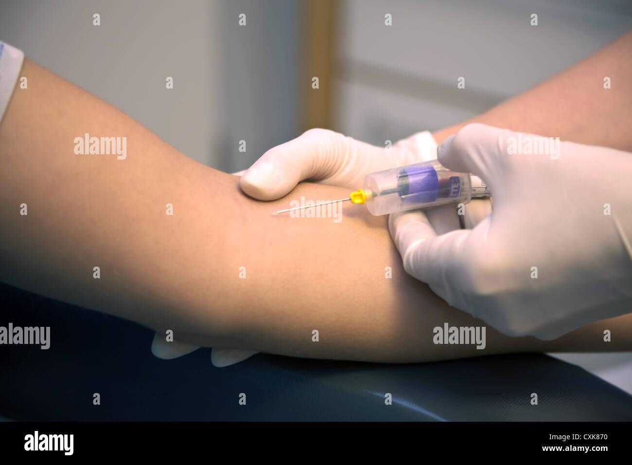 Doctor taking a blood sample Stock Photo - Alamy