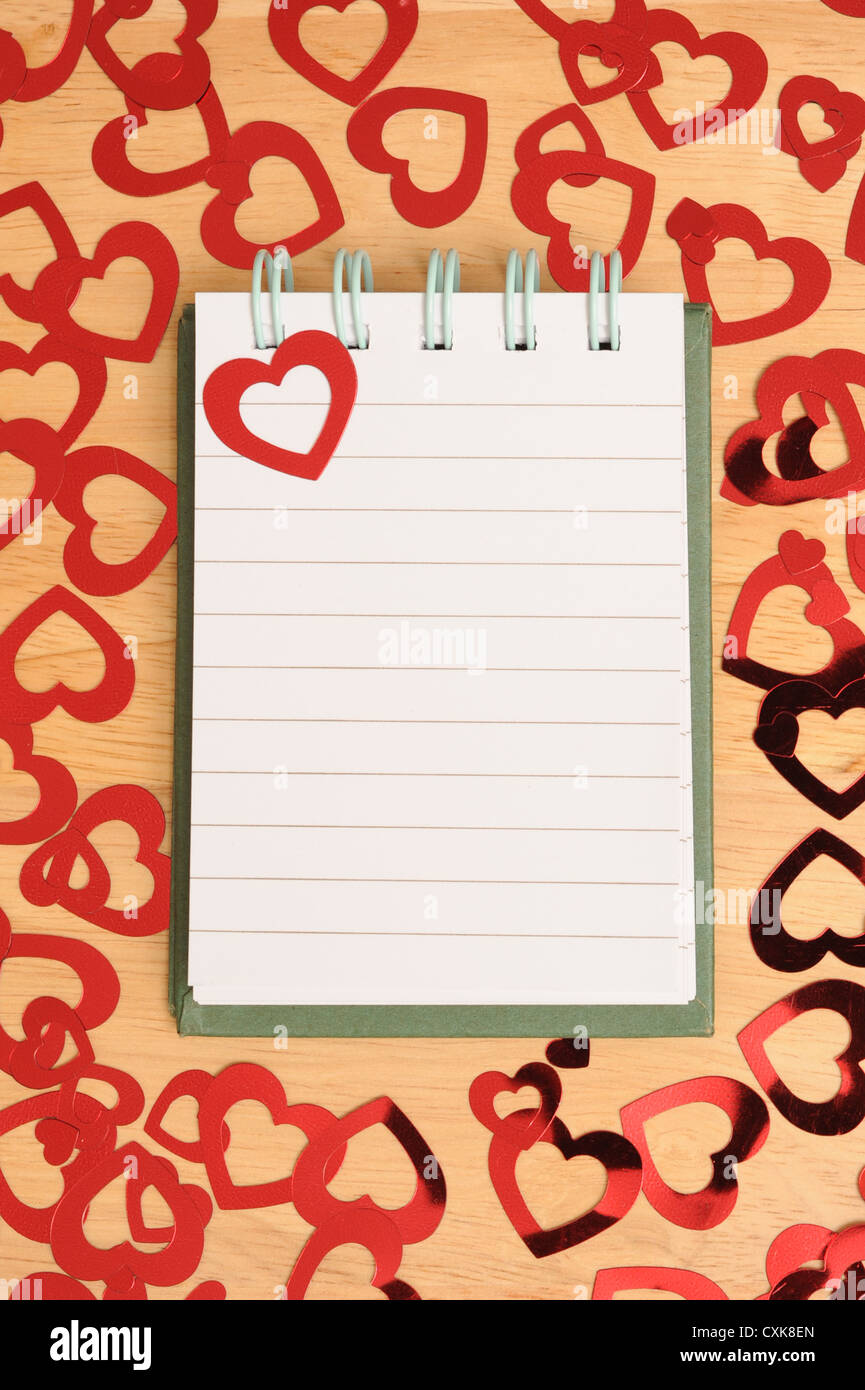 Blank notepad with heart shaped confetti Stock Photo - Alamy