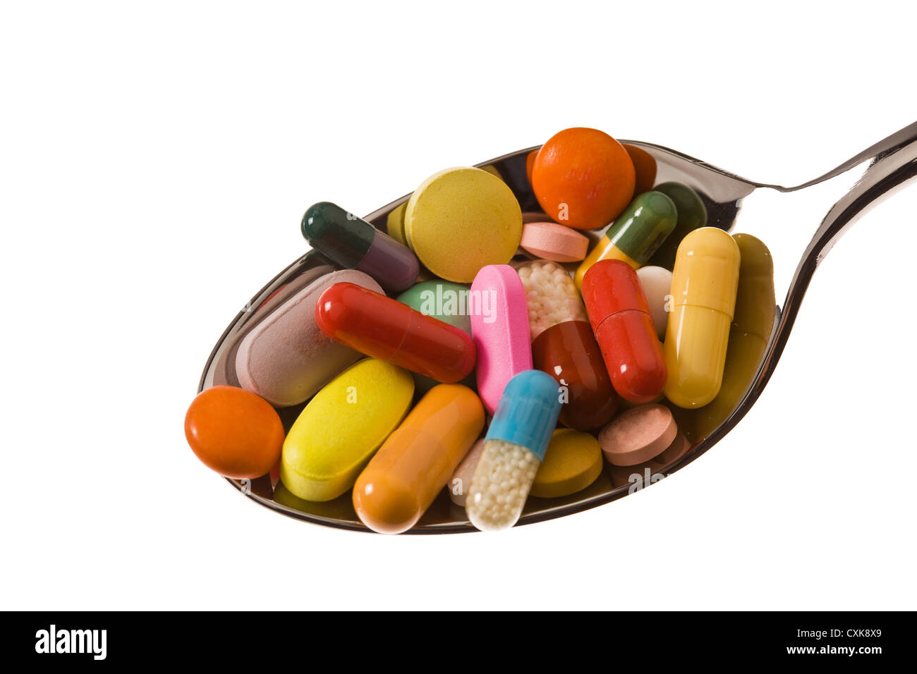 On a spoon lying tablets Stock Photo - Alamy