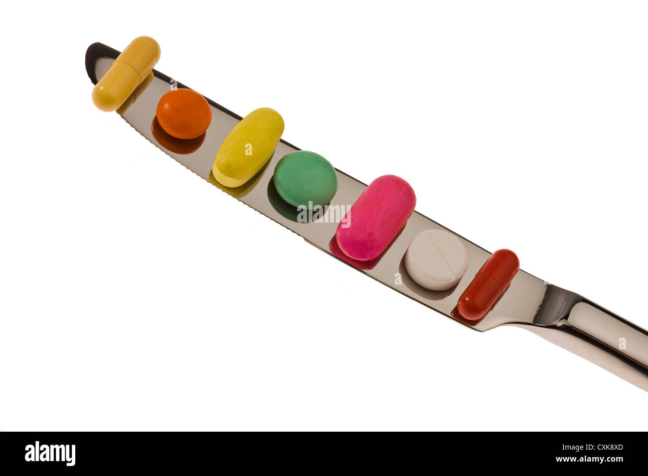 Pills and medicine on a knife Stock Photo - Alamy