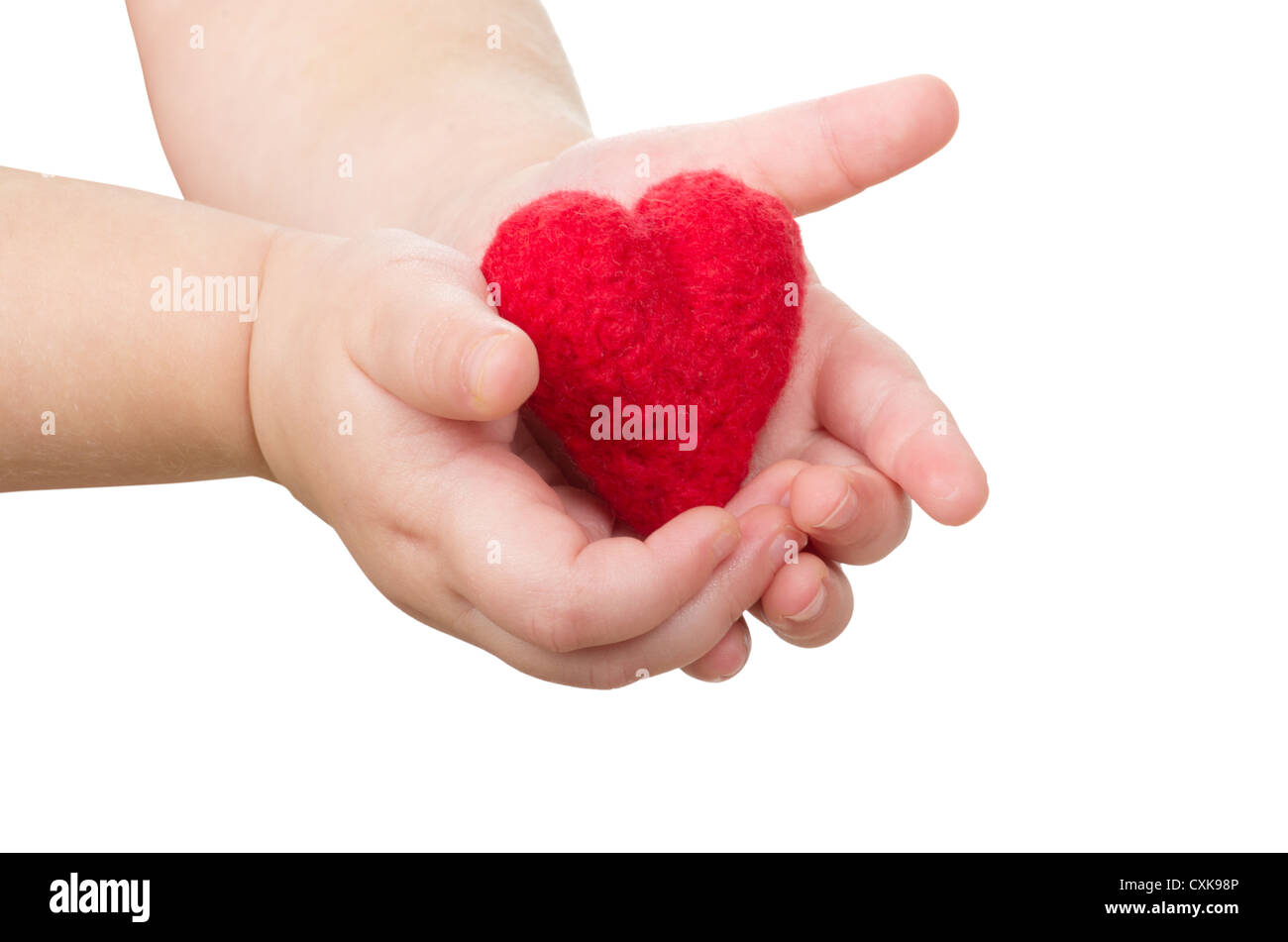 Child's hands with a red heart Stock Photo - Alamy
