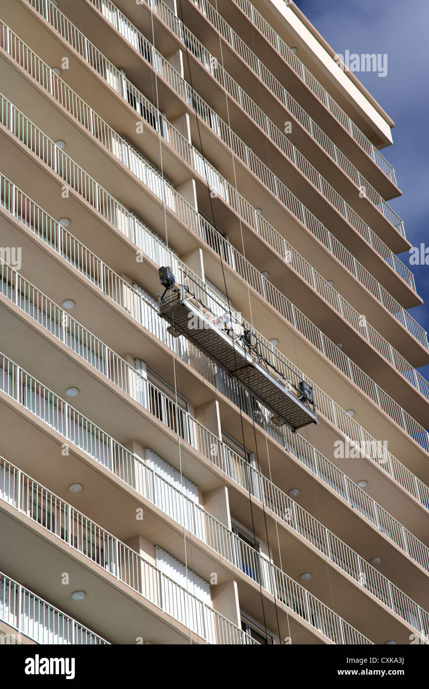 maintenance and cleaning crew on platform lift on apartments beachfront ...
