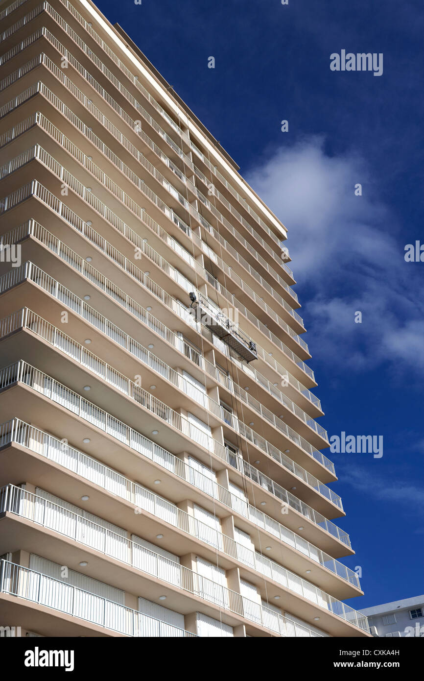 maintenance and cleaning crew on platform lift on apartments beachfront ...