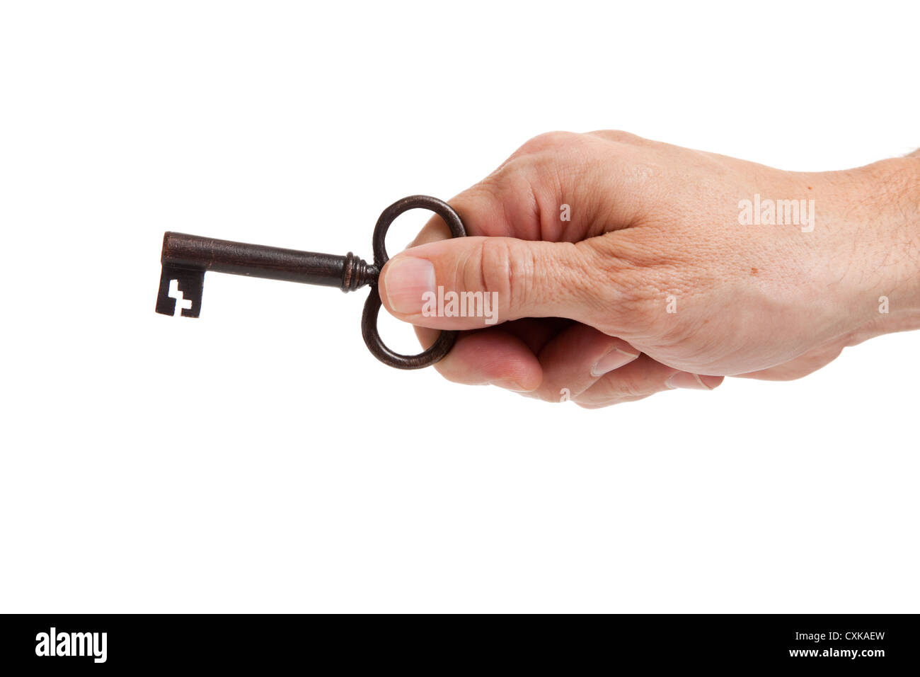 Hand holding an antique skeleton key on a white background Stock Photo ...