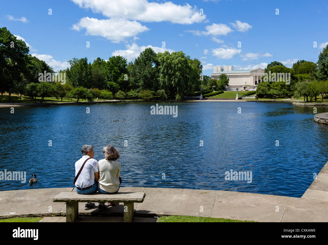 Couple sitting on a bench by Wade Lagoon Cleveland Museum of Art behind ...