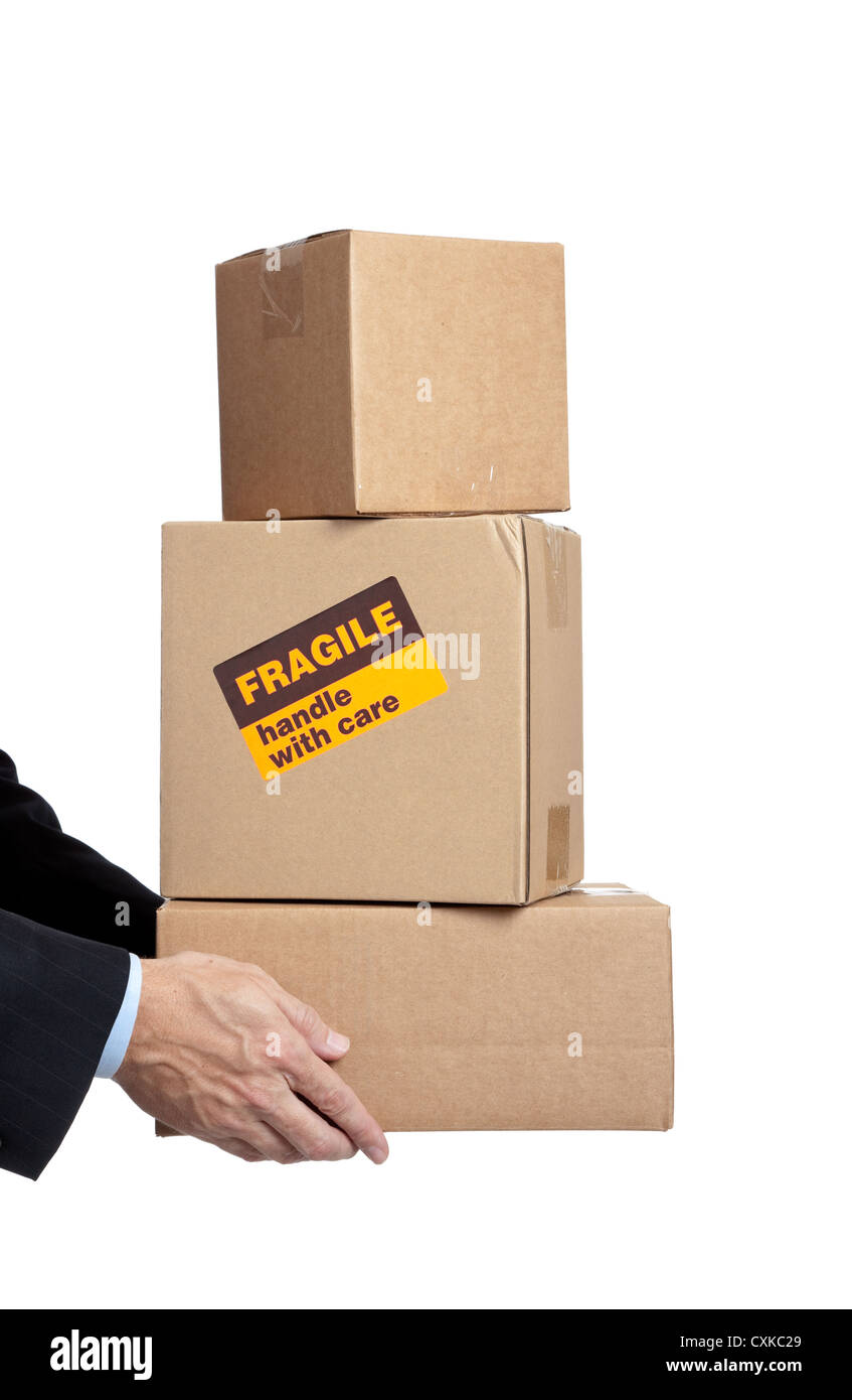 Businessman's hands holding a stack of packing boxes with a fragile ...