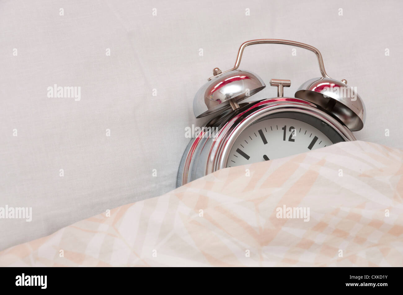 Alarm clock sleeping in bed Stock Photo - Alamy