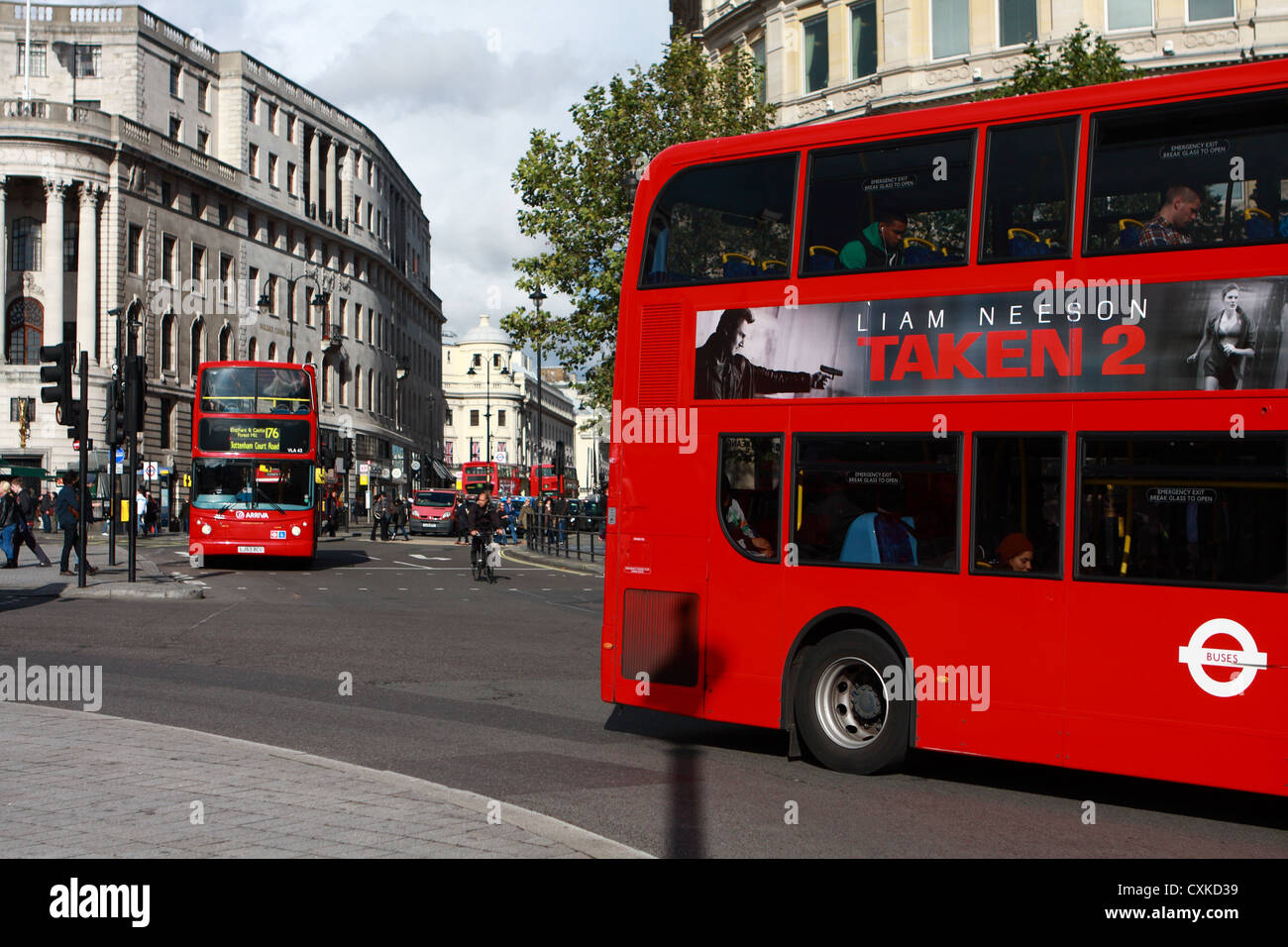 Red double decker buses traveling in London Stock Photo - Alamy