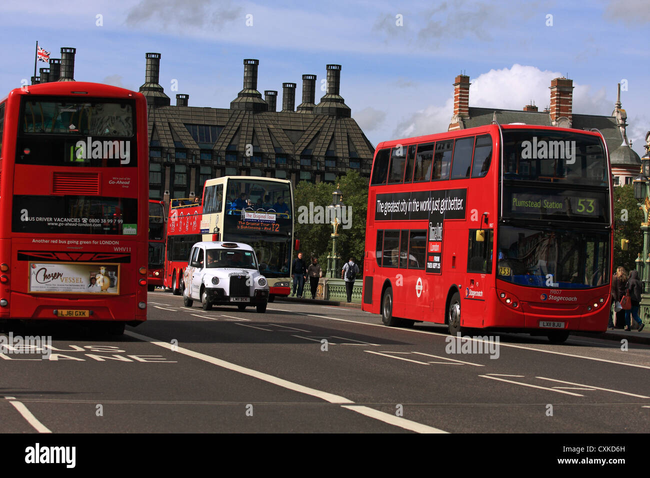 London double decker buses and a taxi traveling over Westminster Bridge ...