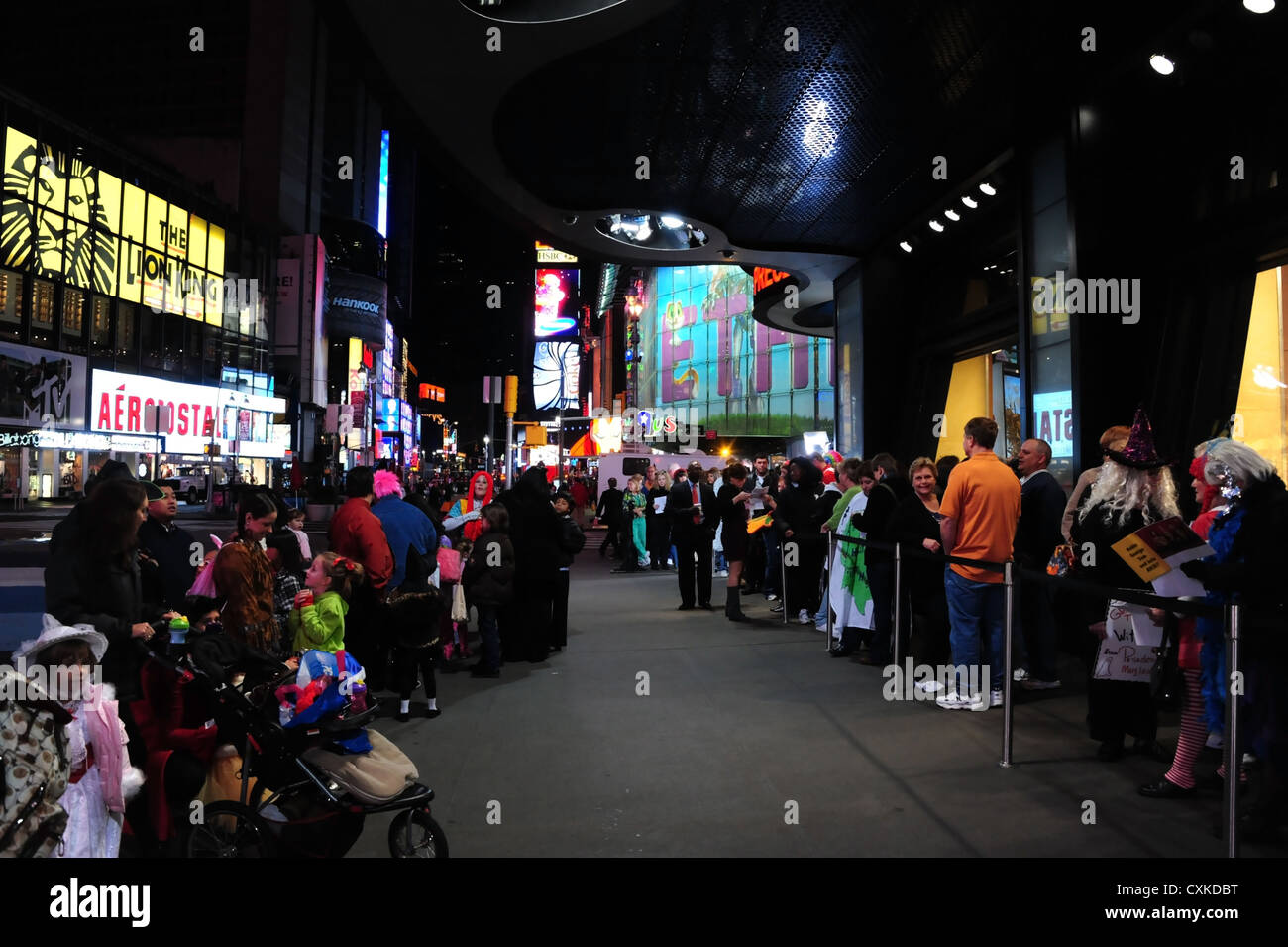 Night neon view, to Duffy Square, 2 lines people in Halloween costumes ...