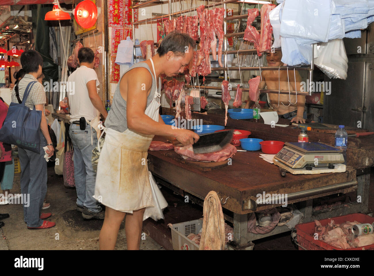 Butcher cutting meat at outdoor street market Central district, Hong ...
