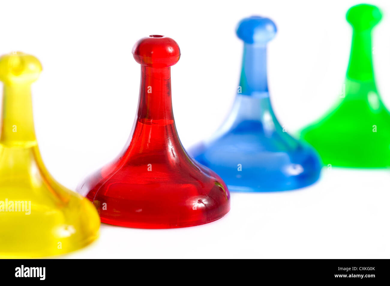 A row of colorful generic game pieces on a white background, focus is ...