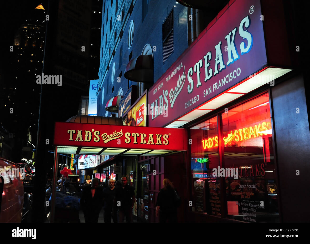 Night neon oblique view, towards 7th Avenue, people walking sidewalk ...