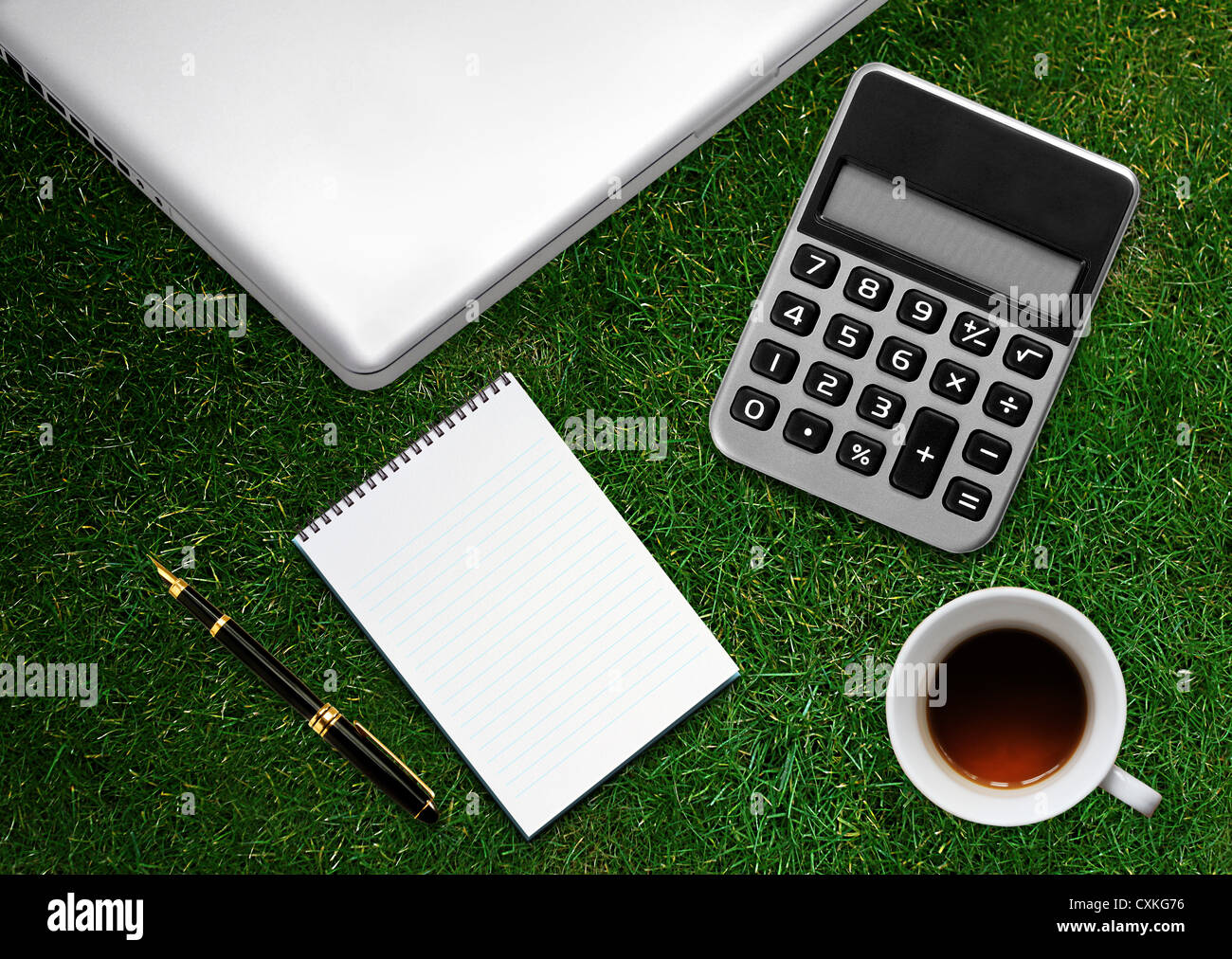 business desktop with laptop, notepad, calculator, envelops and coffee ...