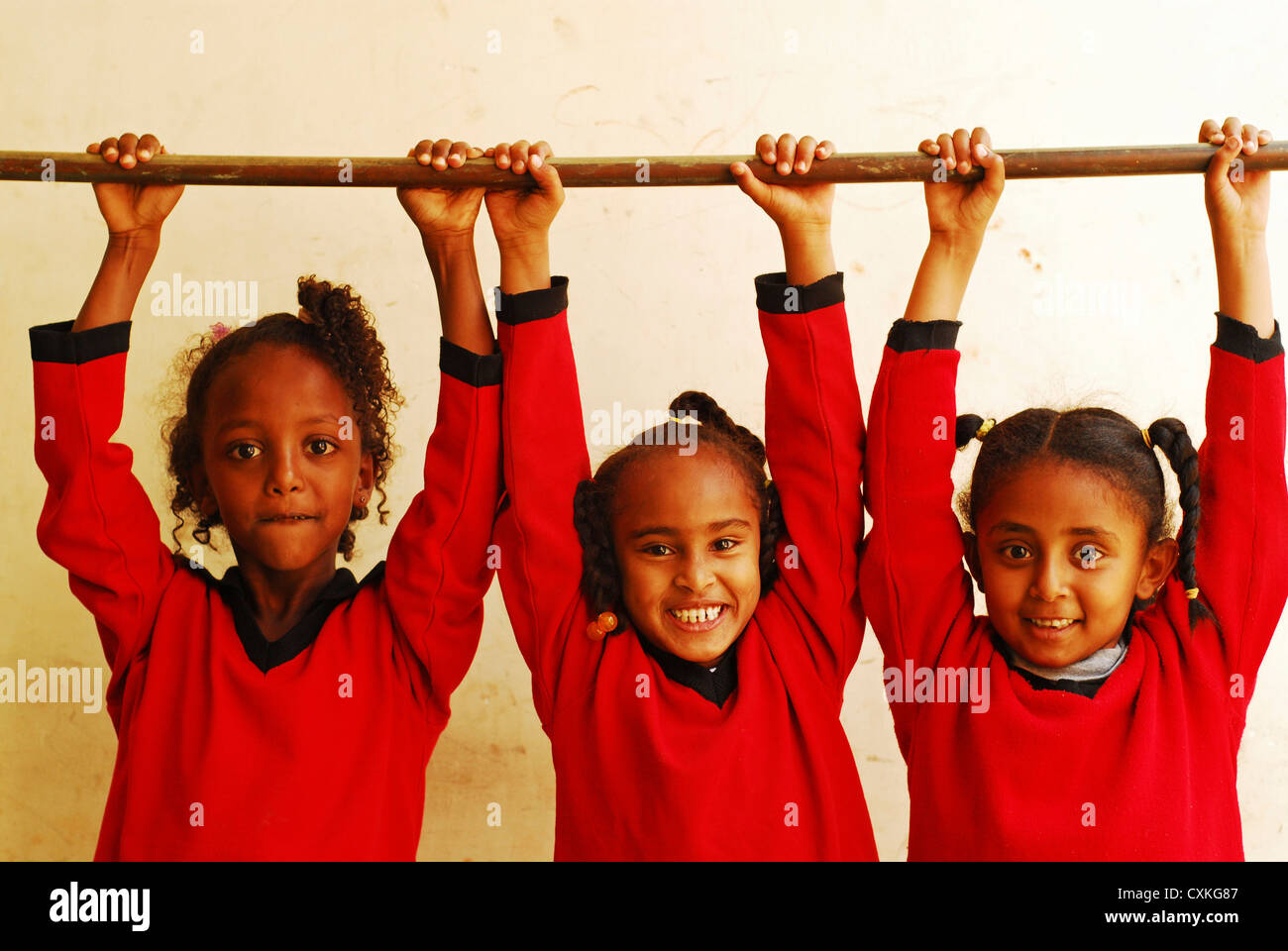 Eritrea, Asmara, portrait of happy African school children in a row holding a bamboo. (MR Stock ...