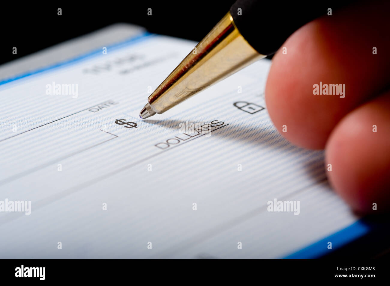 A macro of a ball point pen beginning to write a signature on a check ...