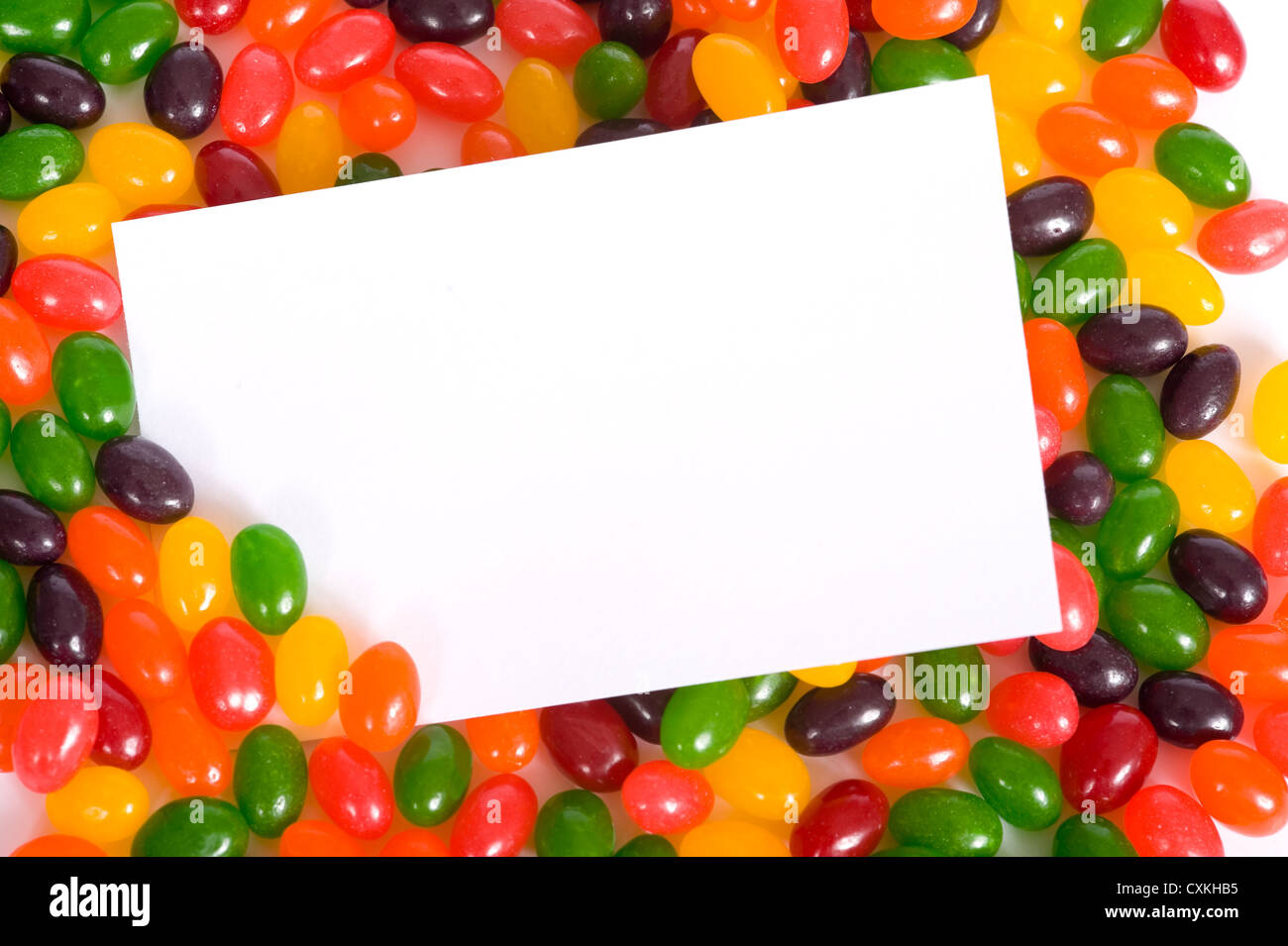 A white blank note-card surrounded by multi-color jelly beans, Easter ...
