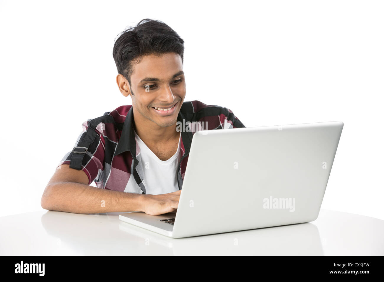 Asian male student working at a desk with a laptop Stock Photo - Alamy