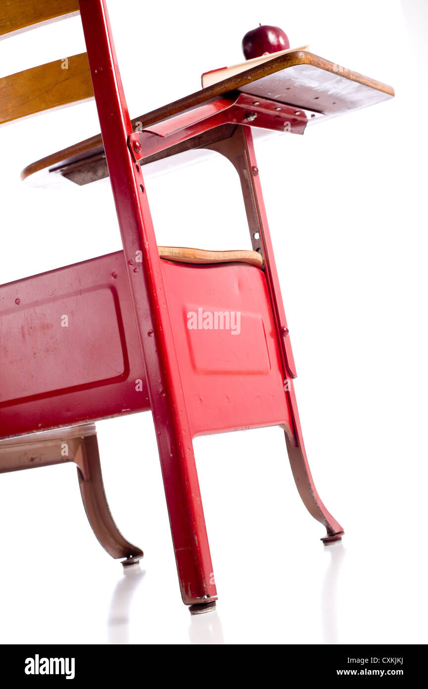 A red, vintage school desk on a white background with books and an ...