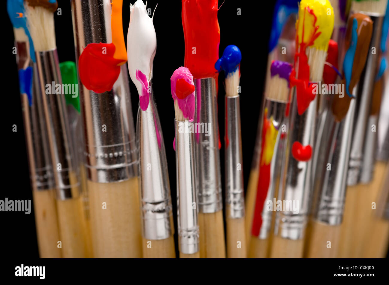 A group of multi-color paintbrushes on a black background Stock Photo ...