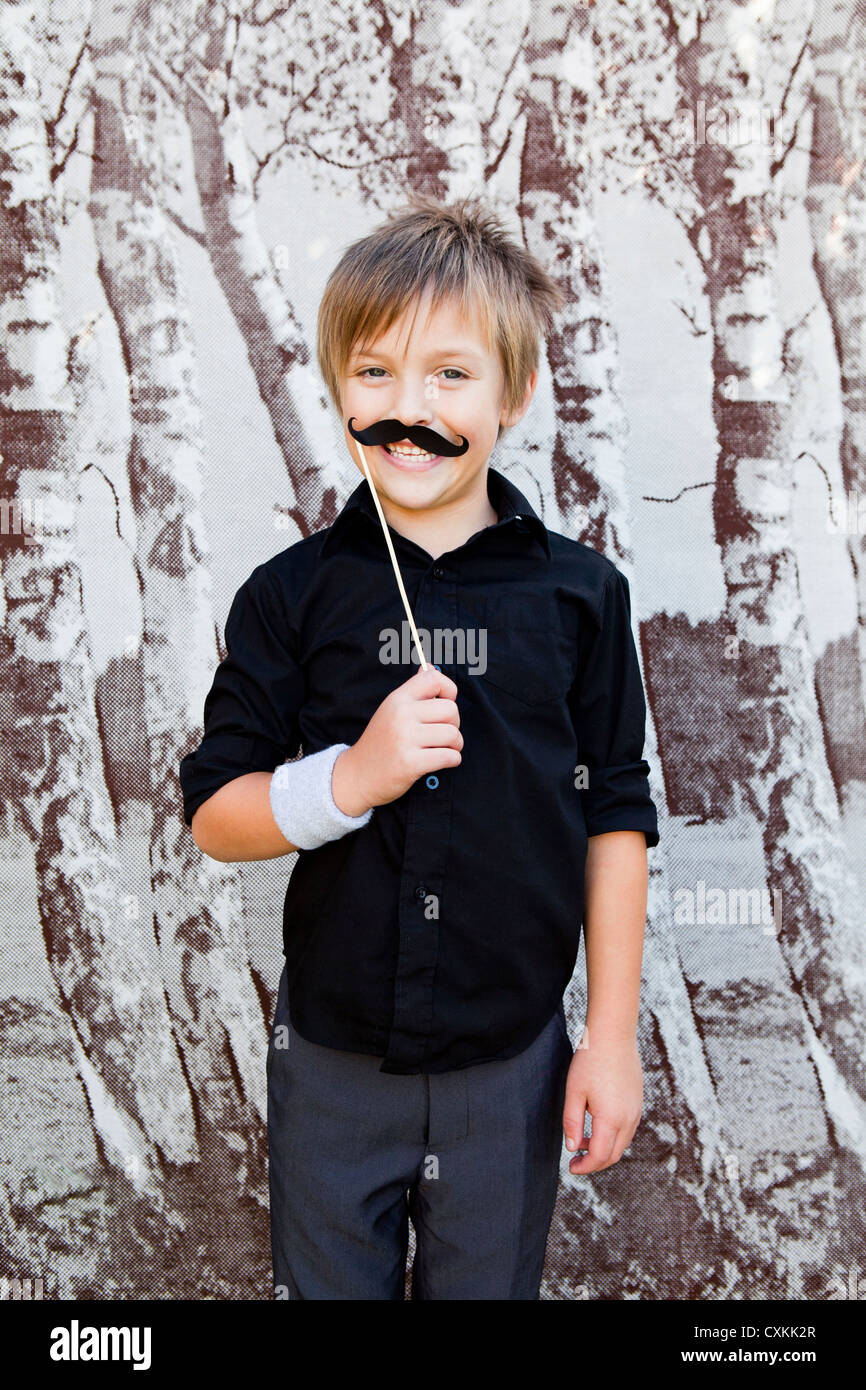Young boy with mustache on stick Stock Photo - Alamy