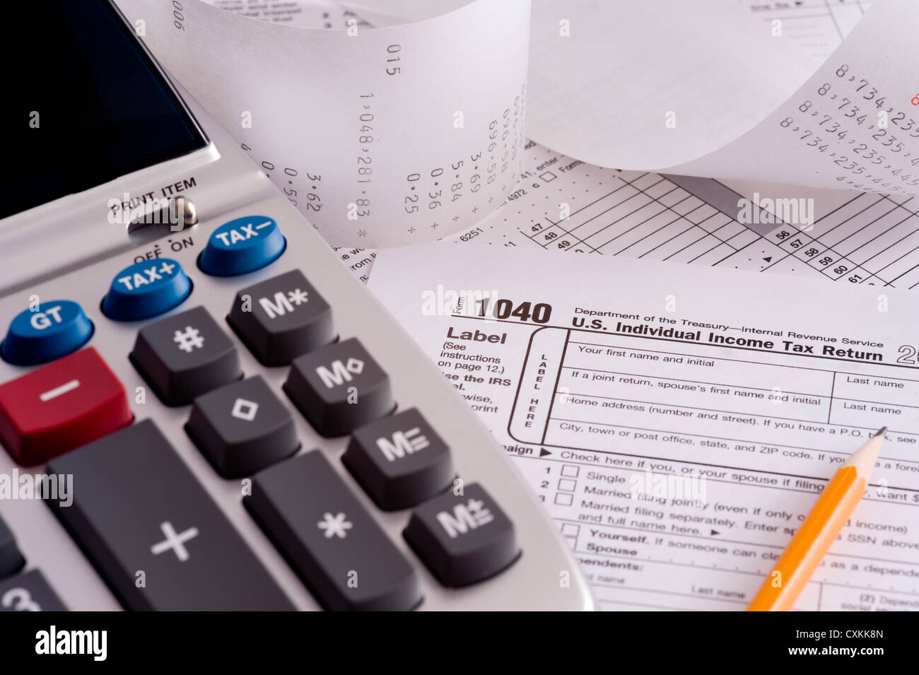 An adding machine or calculator with adding machine tape or paper and ...