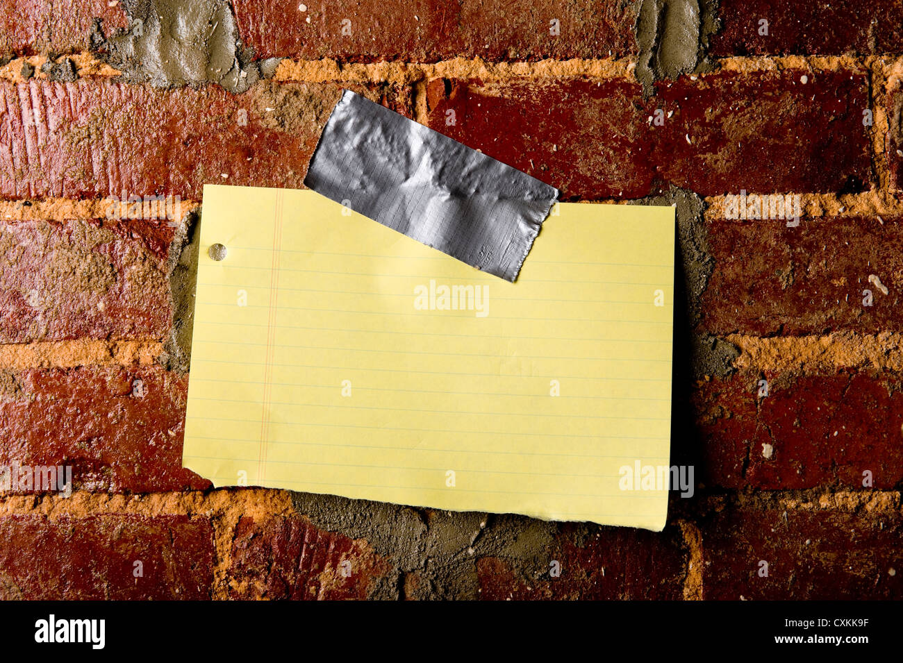 A Blank Sheet Of Paper Taped To A Brick Wall With Copy Space Stock a-blank-sheet-of-paper-taped-to-a-brick-wall-with-copy-space-stock
