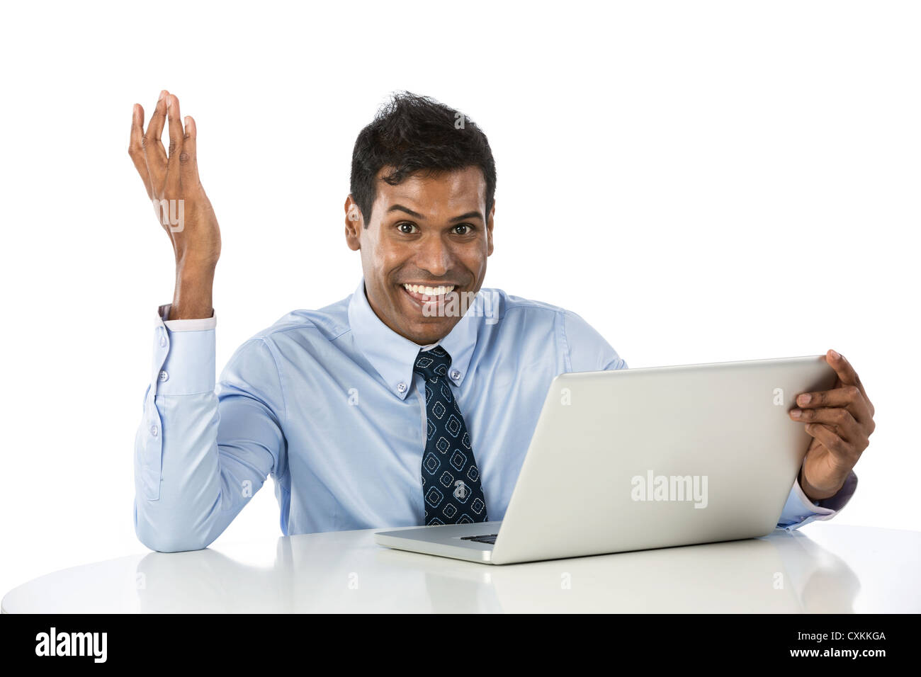 Portrait of a really happy Indian business man working with his laptop ...