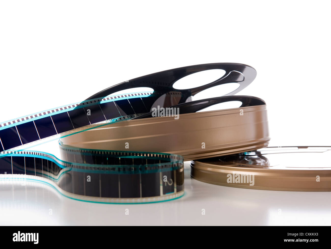 A container of film strip, film reel and film can on a white background ...