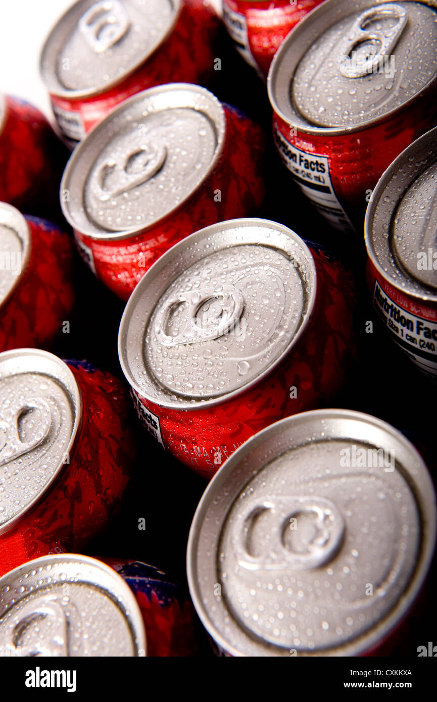 Cans of ice cold red soda pop in aluminum cans forming a background ...