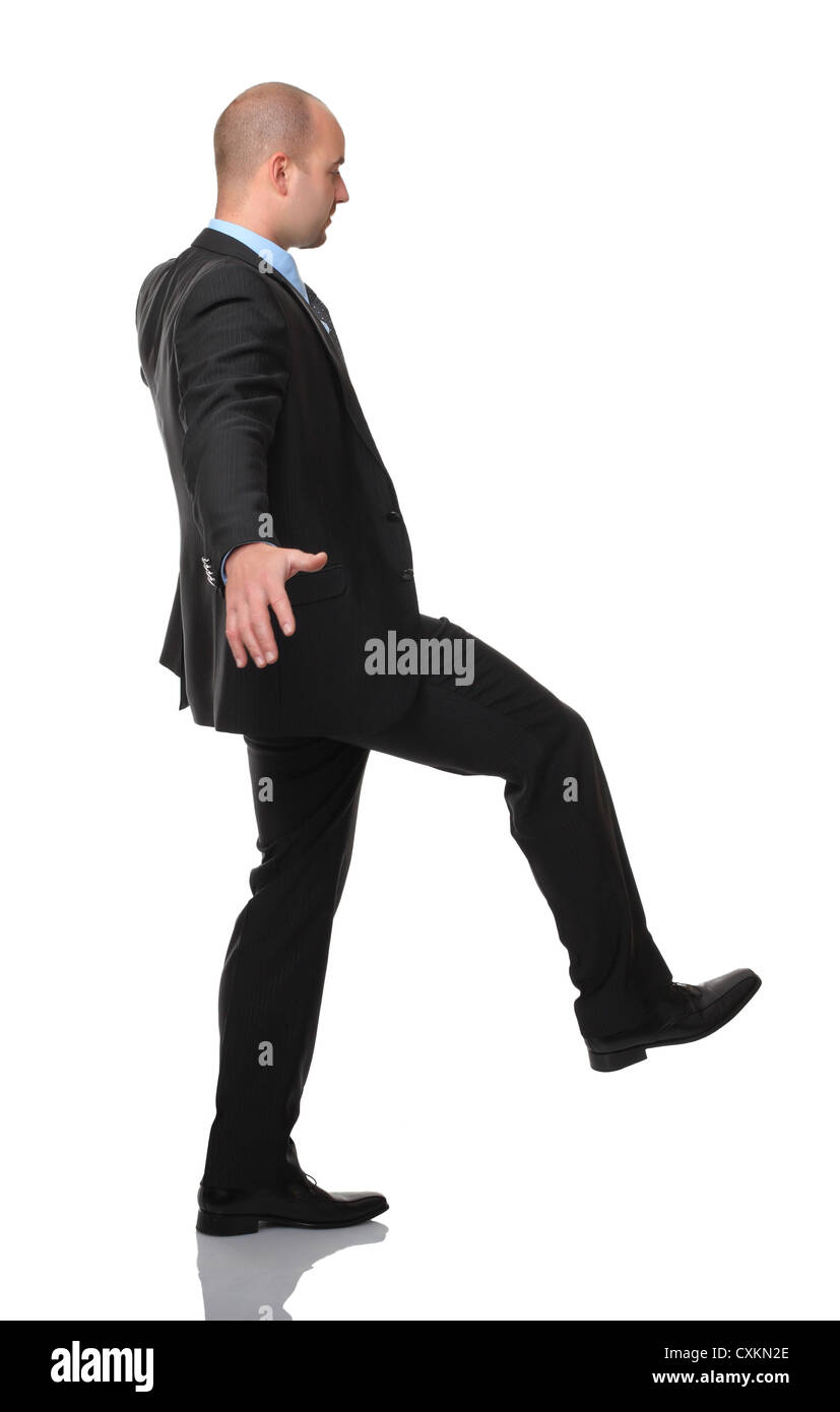 businessman try to balance himself on white background Stock Photo - Alamy